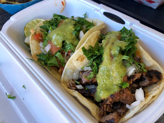 Their carne asada tacos prove they're not just a one-trick pony. Generous cilantro, lime wedges, and green sauce create a fiesta for your taste buds.