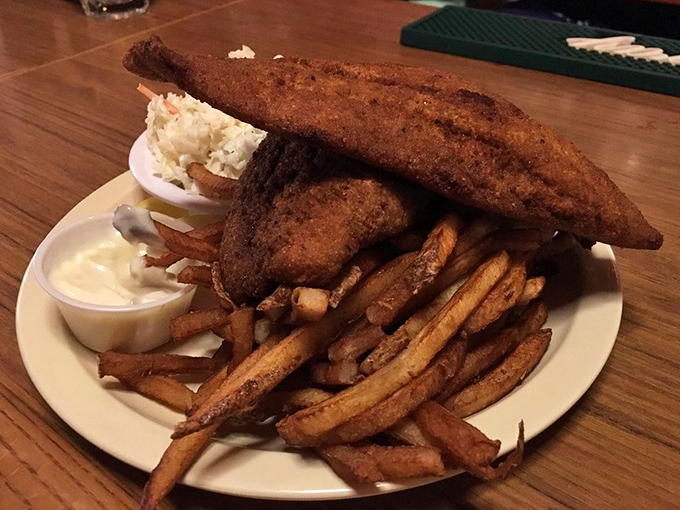 This isn't just fried fish&mdash;it's edible architecture. The perfectly golden-brown catfish stands tall over those legendary fries like a delicious monument to Lake Erie's bounty.
