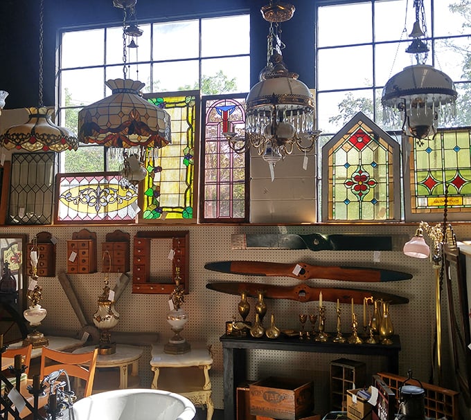 Stained glass windows and vintage chandeliers create a cathedral of kitsch where light filters through decades of craftsmanship.