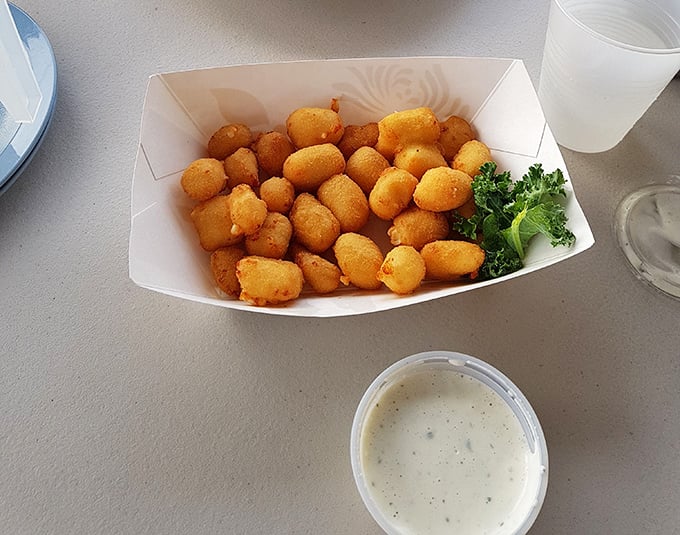 Golden-fried cheese curds that would make any Wisconsin grandmother proud &ndash; crispy exterior giving way to that perfect molten cheese pull that defines Midwestern happiness.