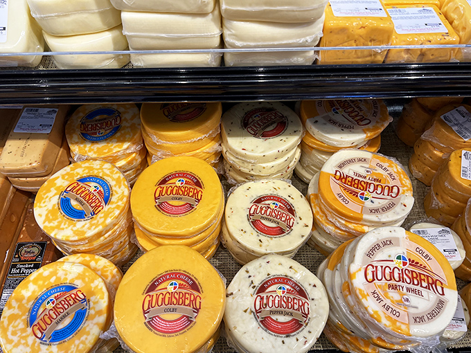 A colorful parade of cheese wheels that would make a Frenchman weep with joy. Each label promises a different journey for your taste buds.