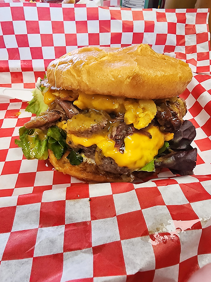 This isn't just a cheeseburger; it's a towering monument to excess that requires a game plan, several napkins, and zero shame.