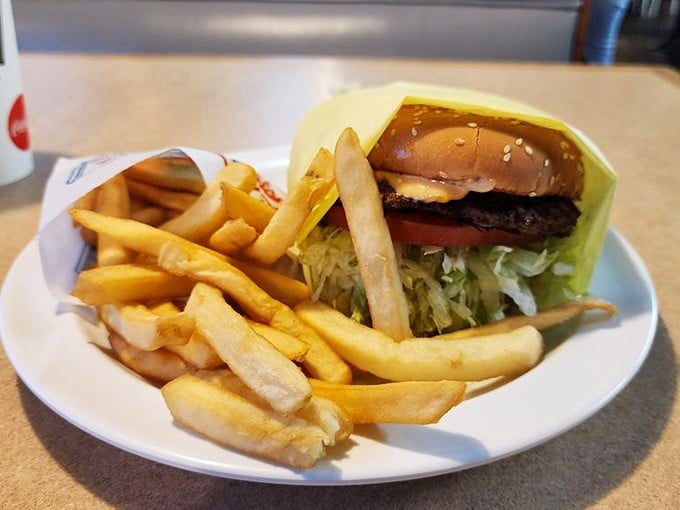 The classic cheeseburger with crispy fries&mdash;architectural perfection where each layer knows its role in this timeless American symphony of flavors.