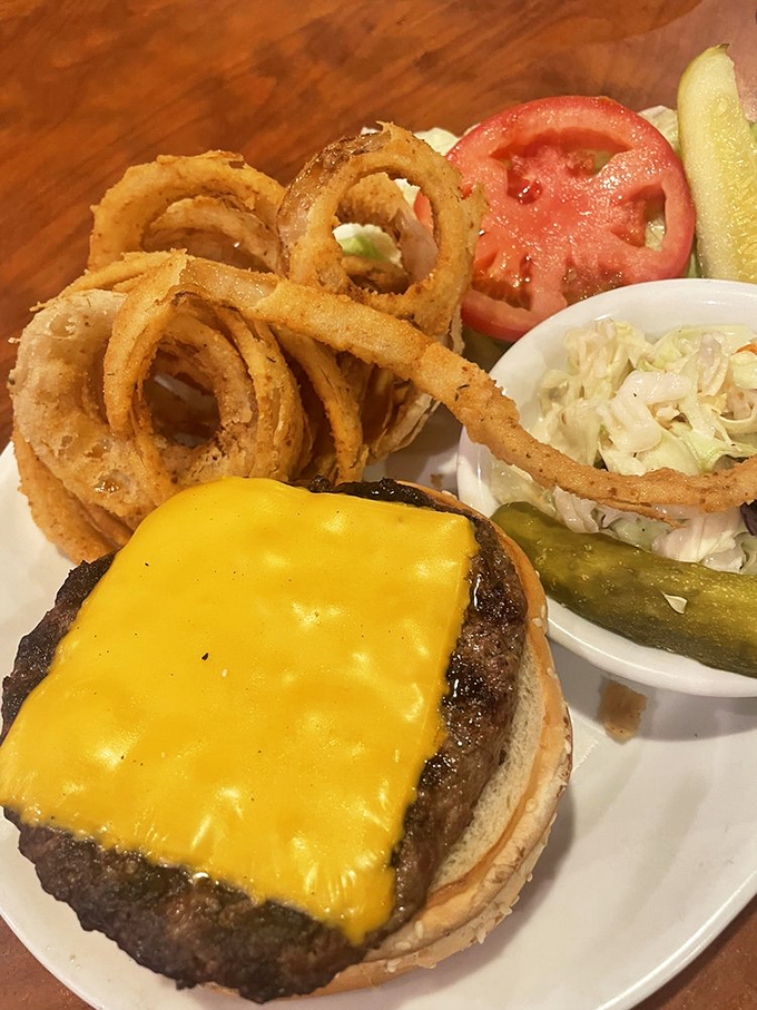 This cheeseburger and onion ring combo looks like it stepped out of a Norman Rockwell painting.