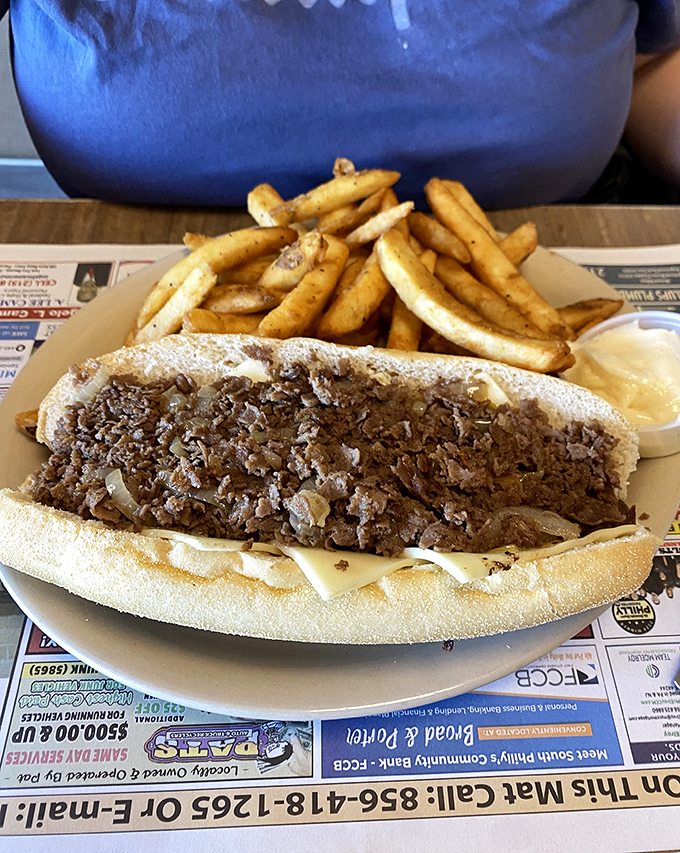 Philly's famous cheesesteak in its natural habitat. Not just a sandwich, but a cultural institution served with a side of civic pride.