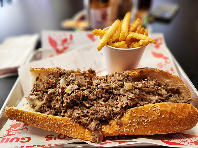 The eternal Philadelphia question answered on a checkered paper: cheesesteak with a side of perfect crinkle-cut fries.