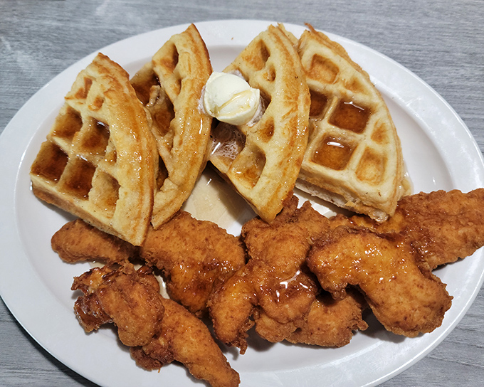 Chicken and waffles unite sweet and savory in perfect harmony, creating breakfast magic on every golden plate.