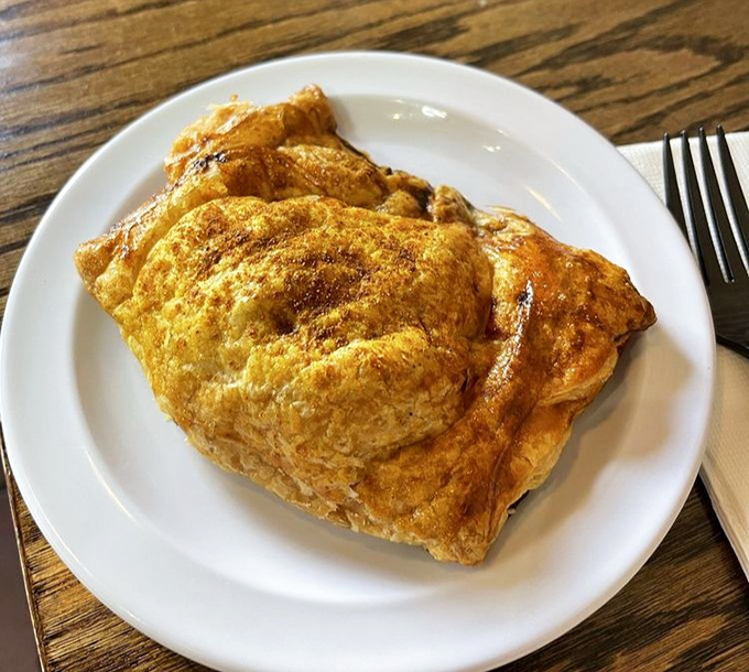Golden, flaky pastry hugging savory chicken curry filling—the British Empire's most delicious colonial influence in handheld form.