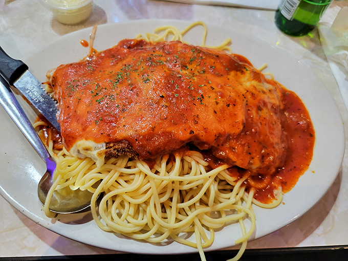 Chicken parm that doesn't know it's in a diner &ndash; this massive portion of saucy, cheesy goodness atop perfectly cooked pasta would make any Italian grandmother nod in approval.