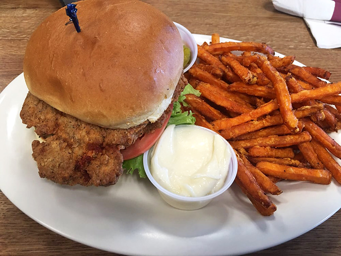 This isn't just a sandwich; it's architecture. Crispy chicken, sweet potato fries, and that pillowy bun create the Taj Mahal of lunch options.