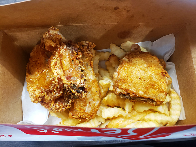 Crispy chicken nestled alongside crinkle-cut fries with a soft roll standing by. This isn't just lunch; it's Southern comfort in basket form.