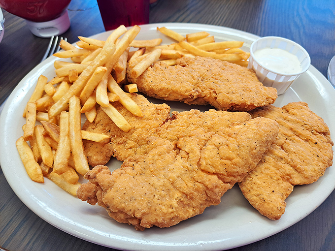 Golden-fried chicken tenders that crunch like autumn leaves, paired with fries so perfect they make ketchup optional&mdash;diner food at its finest.