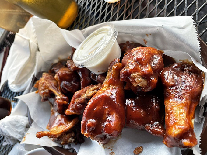These wings aren't just glazed, they're practically lacquered with sticky-sweet sauce—the kind that requires a stack of napkins and zero concern for dignity.