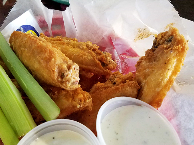 These wings aren't just fried, they're transformed. Crispy, golden-brown armor protecting juicy meat within—the celery sticks standing by like loyal sidekicks.