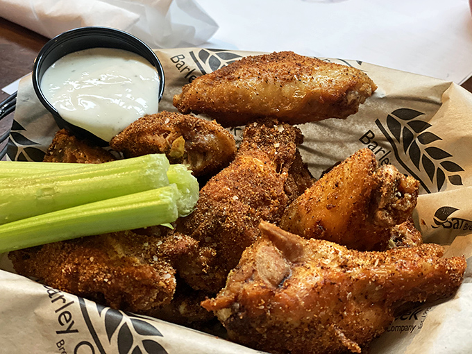 These aren't just wings; they're crispy, golden-brown declarations of flavor independence, served with the cooling counterpoint of fresh celery and creamy dip.