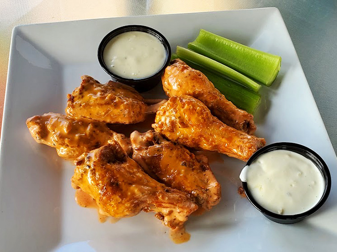 These aren't just wings; they're a masterclass in crispy-saucy balance with cooling dips that bring everything full circle.
