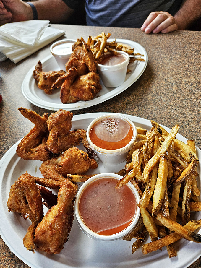 These aren't just wings &ndash; they're flavor vessels with a purpose. Crisp exterior, juicy interior, and that signature hot sauce standing by for dunking duty.