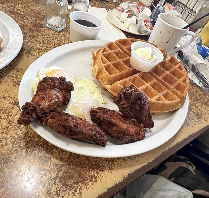 The ultimate breakfast rebellion: crispy fried chicken alongside golden waffles. Who decided this combination works so well? A genius, that's who.
