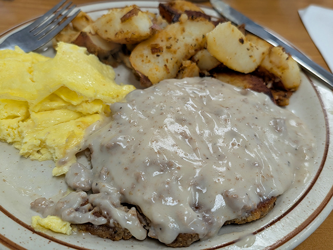 Chicken fried steak swimming in gravy so good you'll want to write it love letters. Comfort food that hugs you from the inside.
