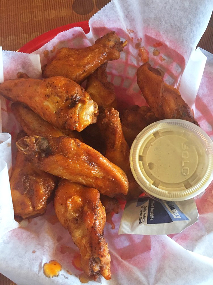 These golden wings arrive with the kind of crispy perfection that makes grown adults do happy dances.