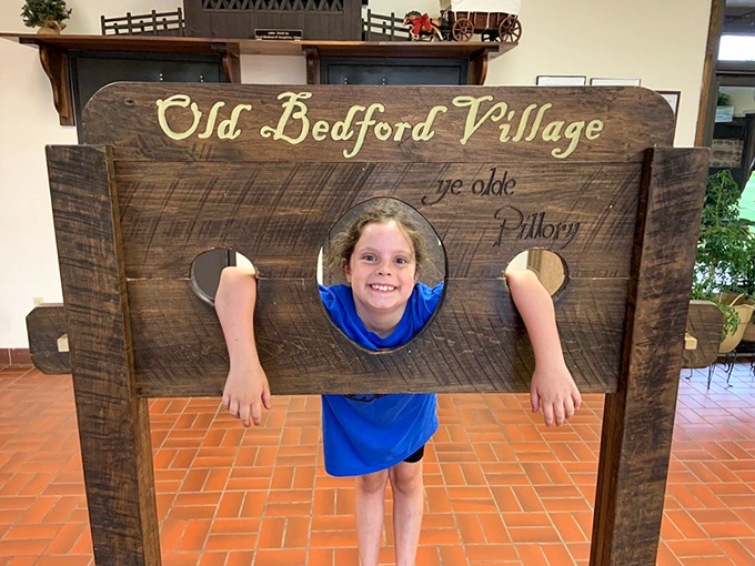 The village pillory: where modern kids discover that the original "face swap" was considerably less comfortable than the digital version.