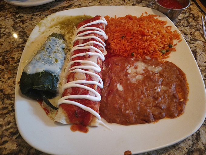 Behold the chimichanga in its natural habitat&mdash;crispy, sauce-draped, and flanked by rice and beans. That drizzle of sour cream is like the bow on a delicious present.