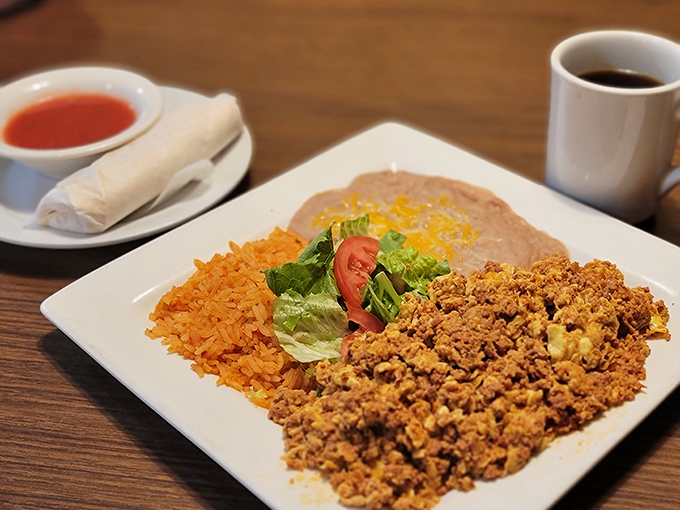 The holy trinity of breakfast: perfectly seasoned chorizo, fluffy eggs, and refried beans. Add a tortilla and you've got edible happiness.