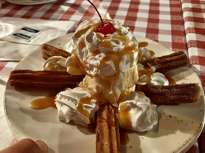 Dessert that makes you feel like a kid again: ice cream surrounded by churros standing at attention like delicious sentinels guarding sweet treasure.