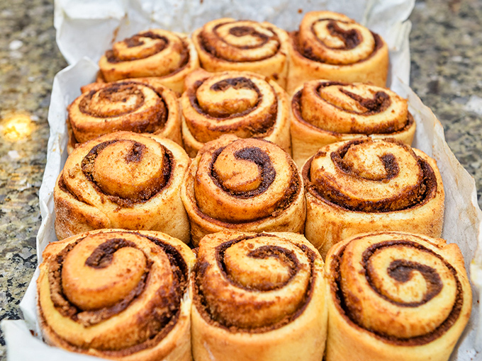 Cinnamon rolls so perfect they'd make a pastry chef weep. The spiral pattern isn't decorative&mdash;it's nature's way of hypnotizing you into ordering a dozen.