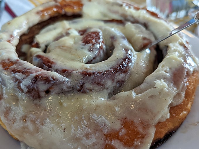Behold the cinnamon roll that ate Manhattan! Cream cheese frosting cascading into every crevice like delicious lava finding its way home.