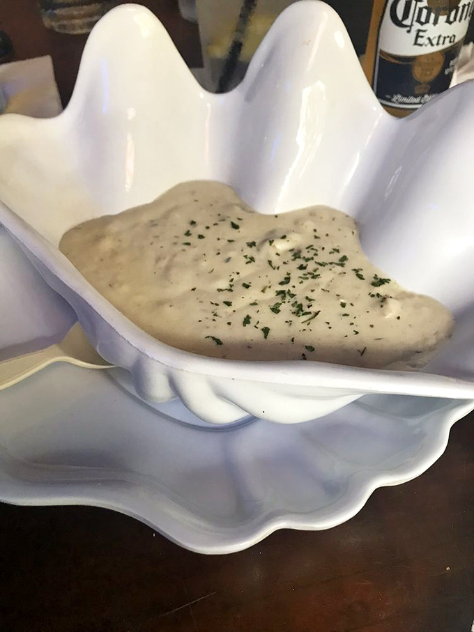 The star of the show: creamy clam chowder served in a shell-shaped bowl. New England tradition meets Florida freshness in every spoonful.