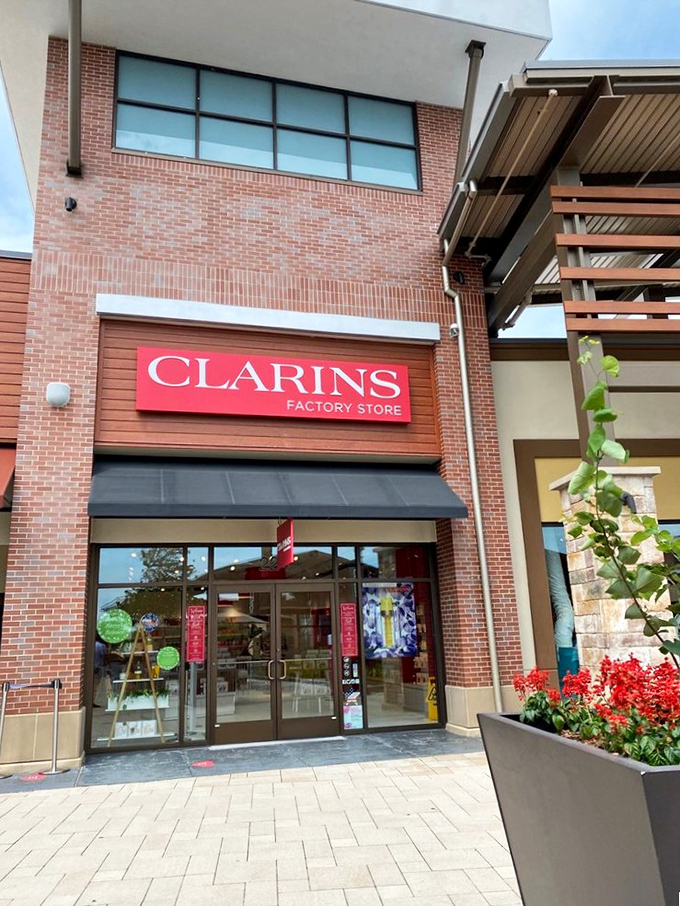 Clarins' bright red storefront stands out like a lipstick mark on a collar, tempting you to indulge in French skincare without the Paris airfare.