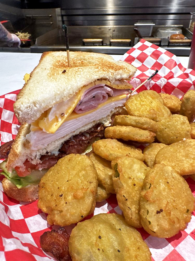 The club sandwich stands tall and proud, while those golden fried pickles are the supporting actors who steal the show.