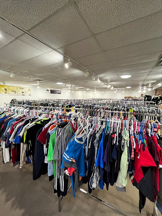 A sea of clothing stretches as far as the eye can see, meticulously organized on white hangers. Rainbow-ordered garments await their second chance at fashion glory.