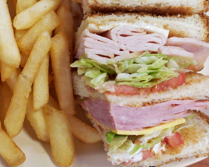 This club sandwich towers like a delicious skyscraper, packed with layers that would make any architect jealous.