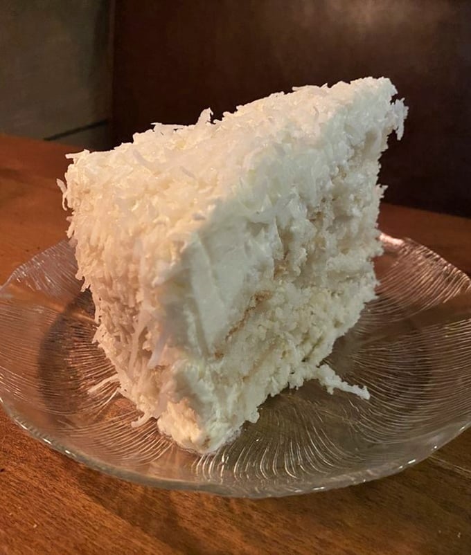 The legendary coconut cake that launched a thousand return visits. This isn't dessert—it's a fluffy, white-cloaked reason to skip the main course entirely.