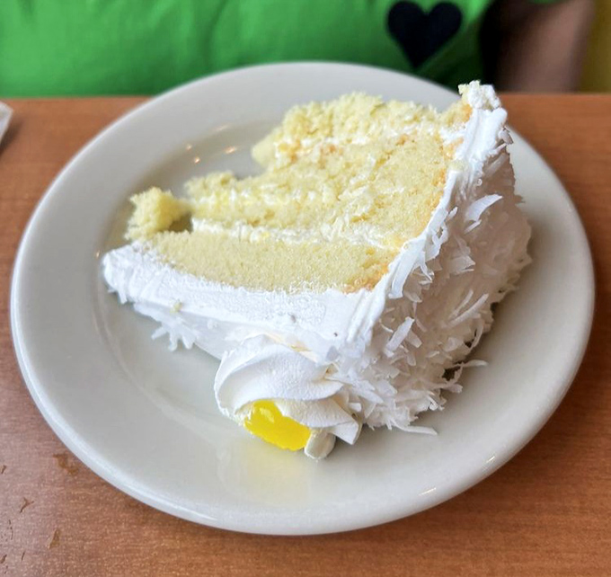 Coconut cake so pristine it belongs in a museum, though it would be a crime not to demolish it with your fork immediately.