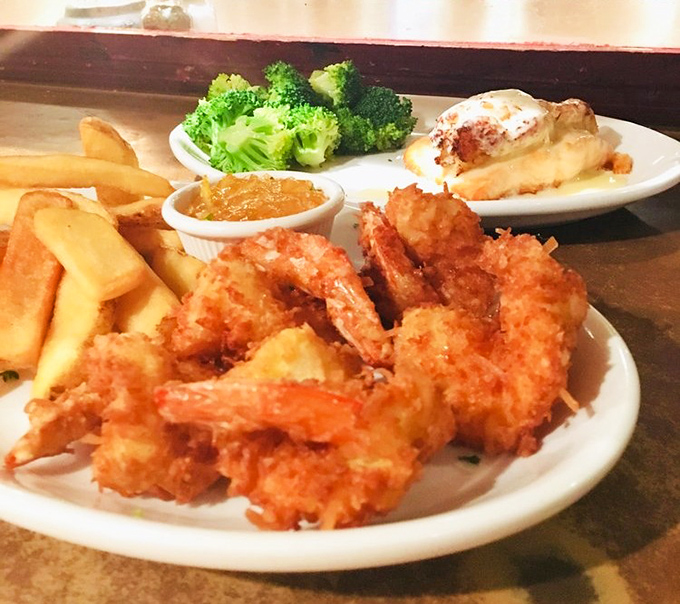 Golden coconut shrimp arrives with crispy perfection that makes every bite a tropical vacation for your taste buds.