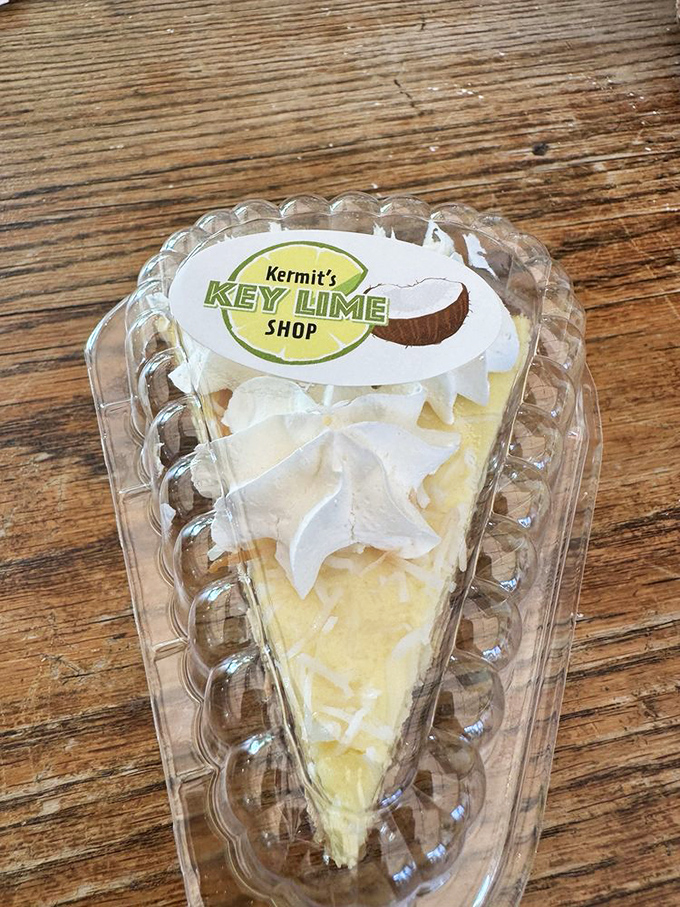 This slice of coconut key lime pie isn't just dessert, it's edible sunshine. The clear container is nature's way of saying "you know you want this."