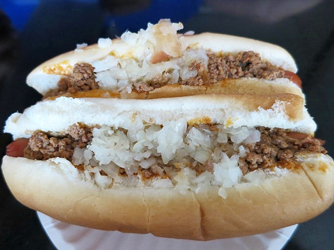 Two chili dogs loaded with onions prove that sometimes the best things come in deliciously messy packages.
