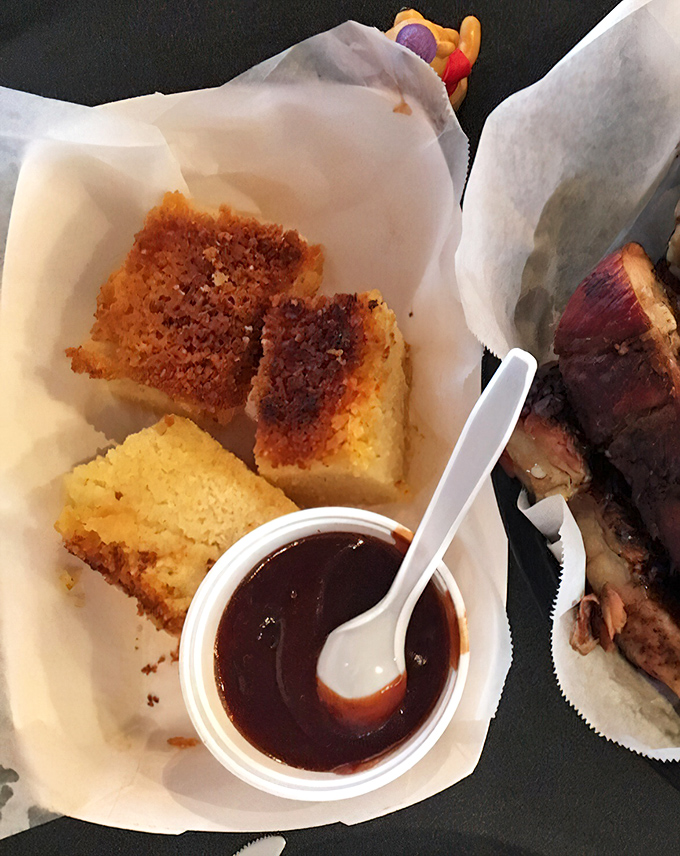 Golden cornbread with a perfectly crisped top—the ideal tool for sopping up every last drop of that magnificent barbecue sauce.