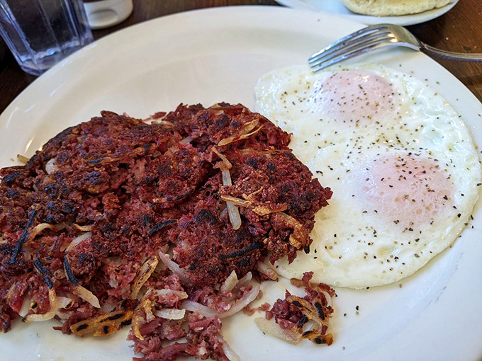 Corned beef hash with that perfect crispy-to-tender ratio sits beside eggs so perfectly cooked they deserve their own Instagram account.