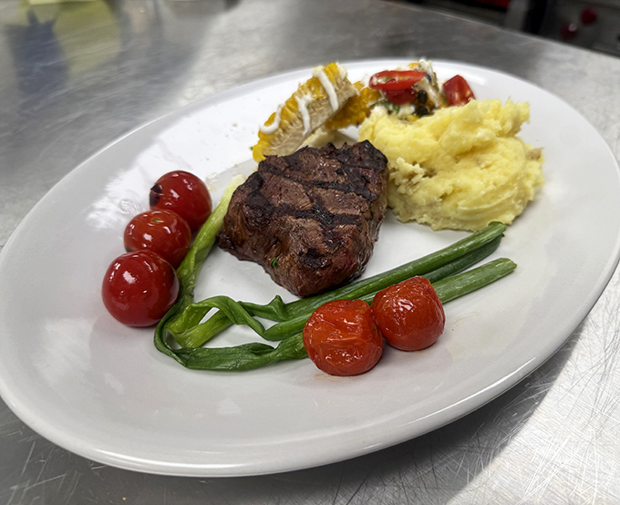 A perfectly seared steak surrounded by cherry tomatoes and mashed potatoes&mdash;proof that sometimes the classics need no improvement.