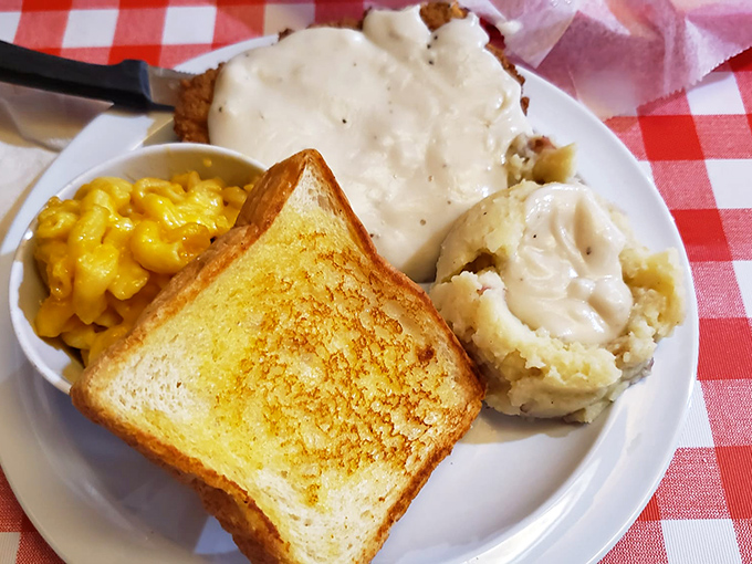 Southern comfort on a plate: golden mac and cheese, buttery toast, and mashed potatoes swimming in gravy. Carb counters, look away &ndash; this is worth every delicious calorie.