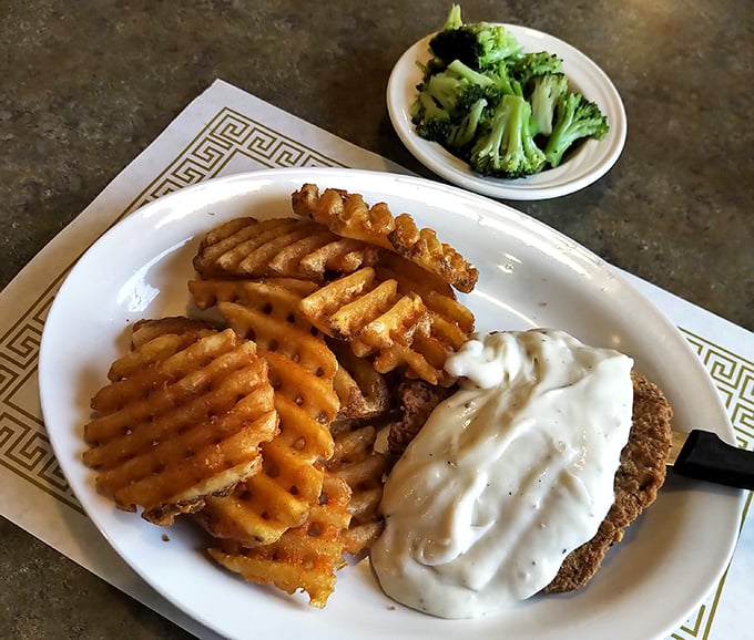 Country fried steak with waffle fries and gravy&mdash;the holy trinity of comfort food that makes your cardiologist wince and your soul sing.