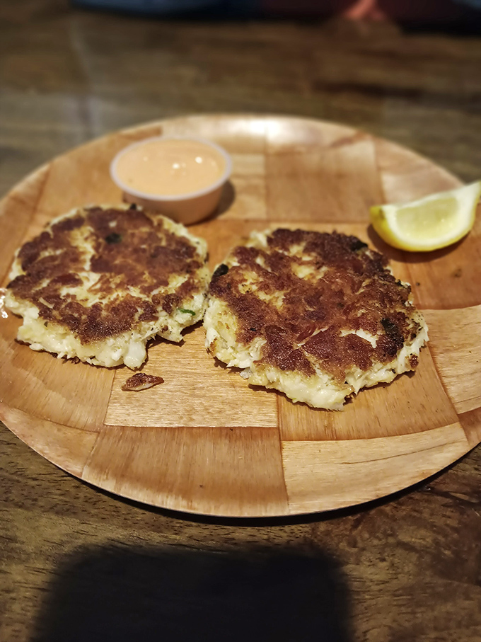 These golden crab cakes aren't just appetizers; they're little discs of joy that make you wonder why you'd ever order anything else.