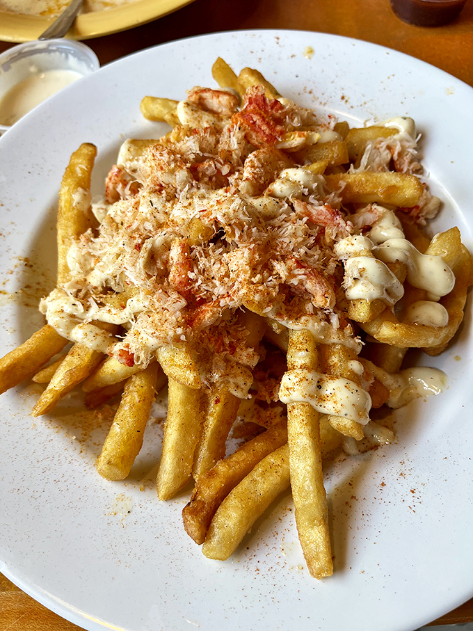 Crab fries that make French fries blush with inadequacy. Crispy potatoes smothered in creamy crab goodness—cardiologists hate this one simple trick!