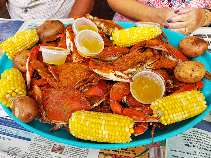 The seafood motherlode has arrived! These vibrant red crabs surrounded by golden corn cobs create a coastal feast worthy of celebration.