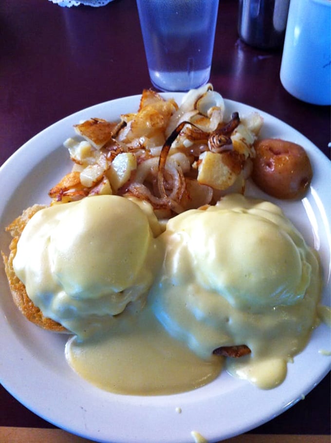 The legendary Crab Cake Benedict in all its glory&mdash;where hollandaise cascades like a golden waterfall over poached eggs perched on genuine crab cakes.