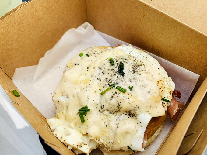 Not your average breakfast sandwich! This savory creation topped with a perfectly runny egg proves Oliboli isn't just playing in the sweet lane.